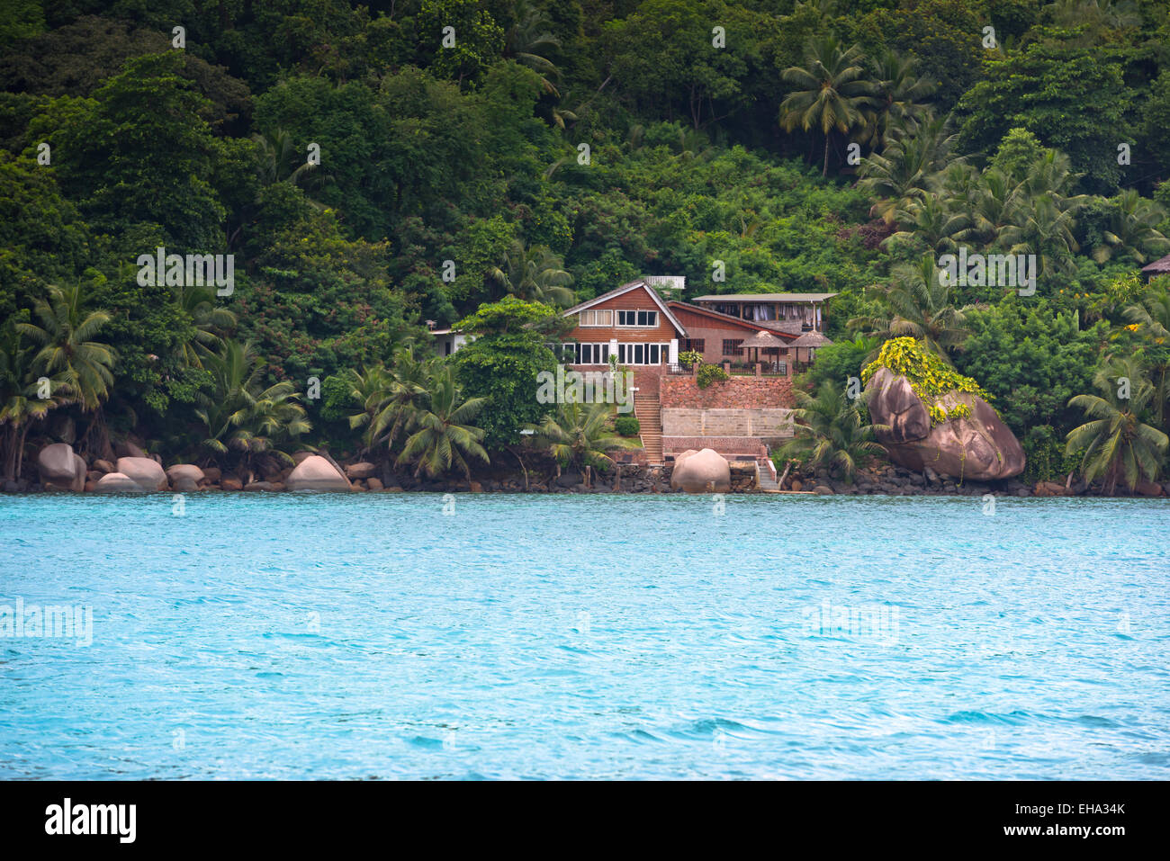 View of Seychelles coastline with a house in the forest. Horizontal ...