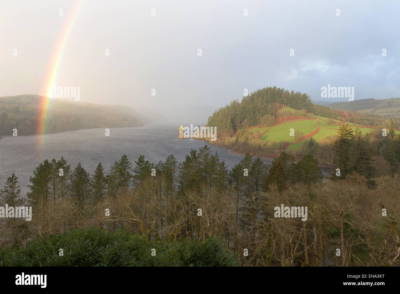 Stunning elevated view of a rainbow forming over Lake Vyrnwy, with the ...