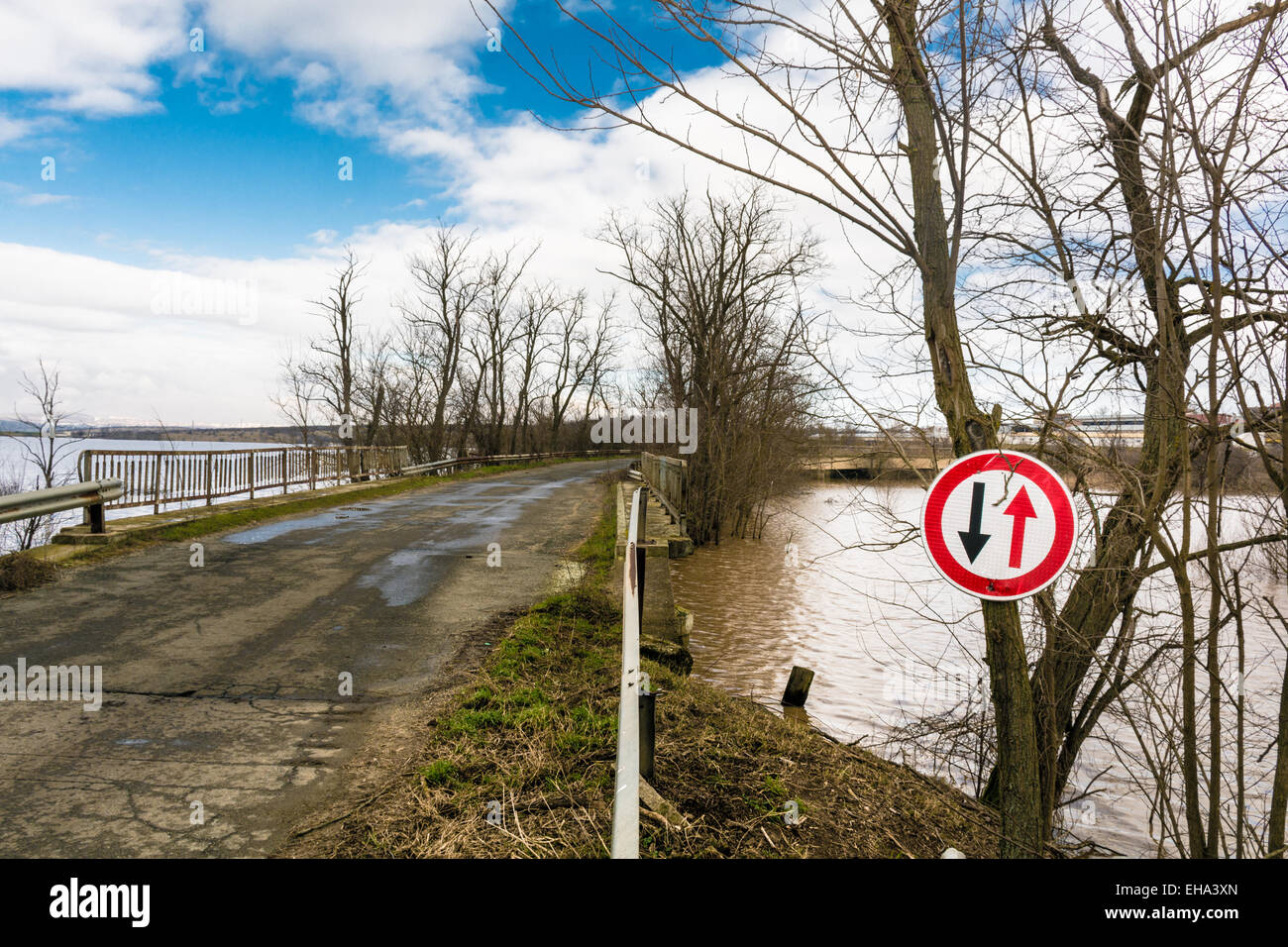 Flood - a natural phenomenon. Beautiful blue sky and road sign with ...