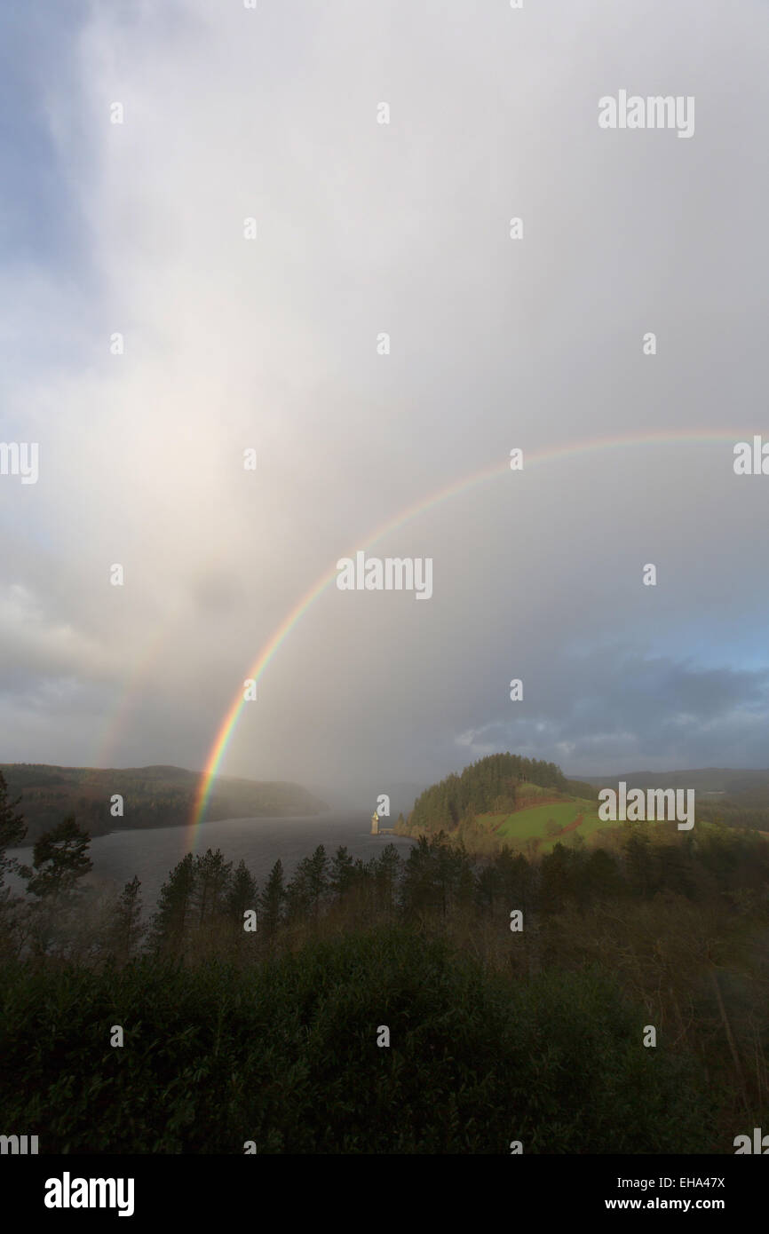 Stunning elevated view of a rainbow forming over Lake Vyrnwy, with the ...