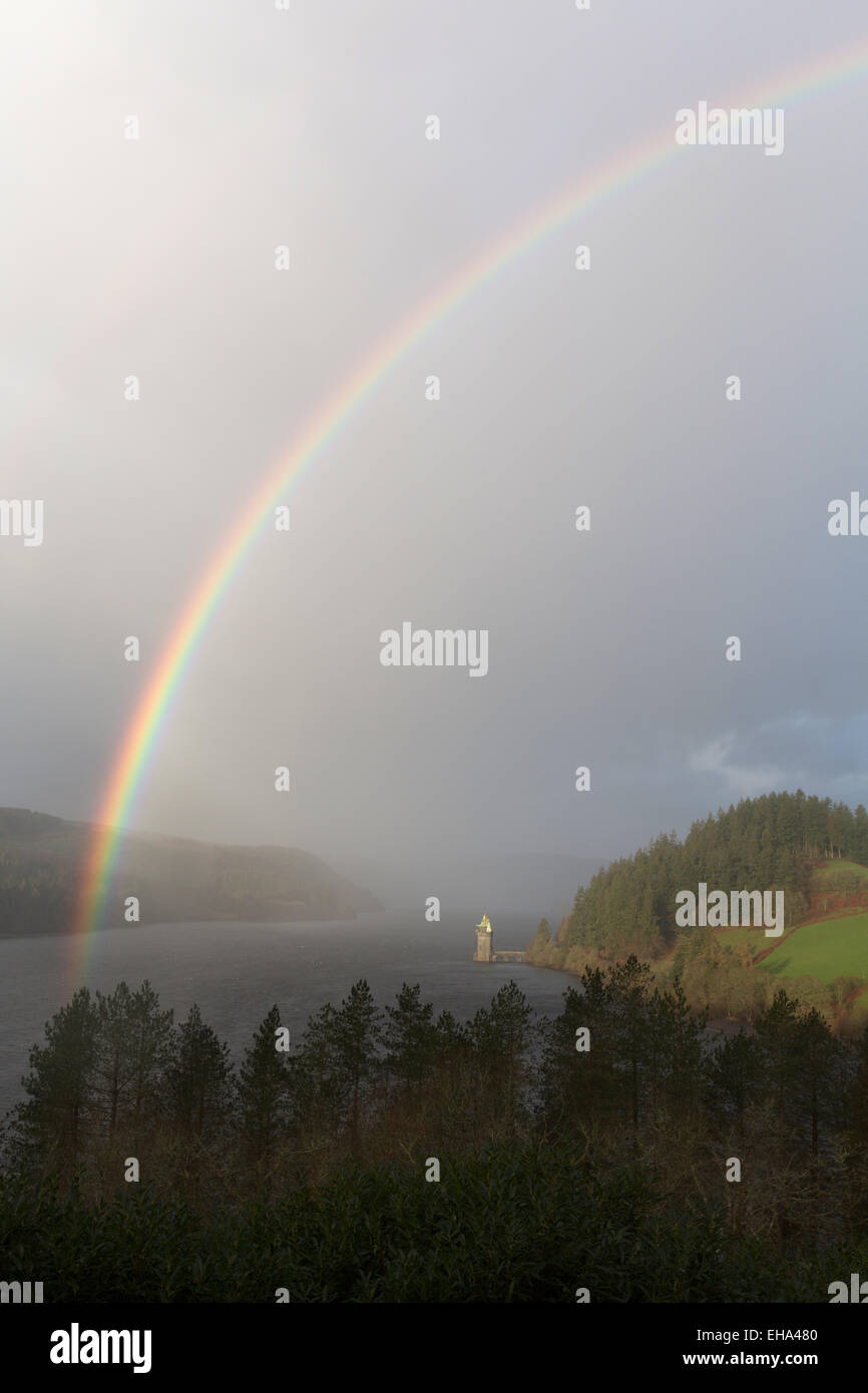 Stunning elevated view of a rainbow forming over Lake Vyrnwy, with the ...