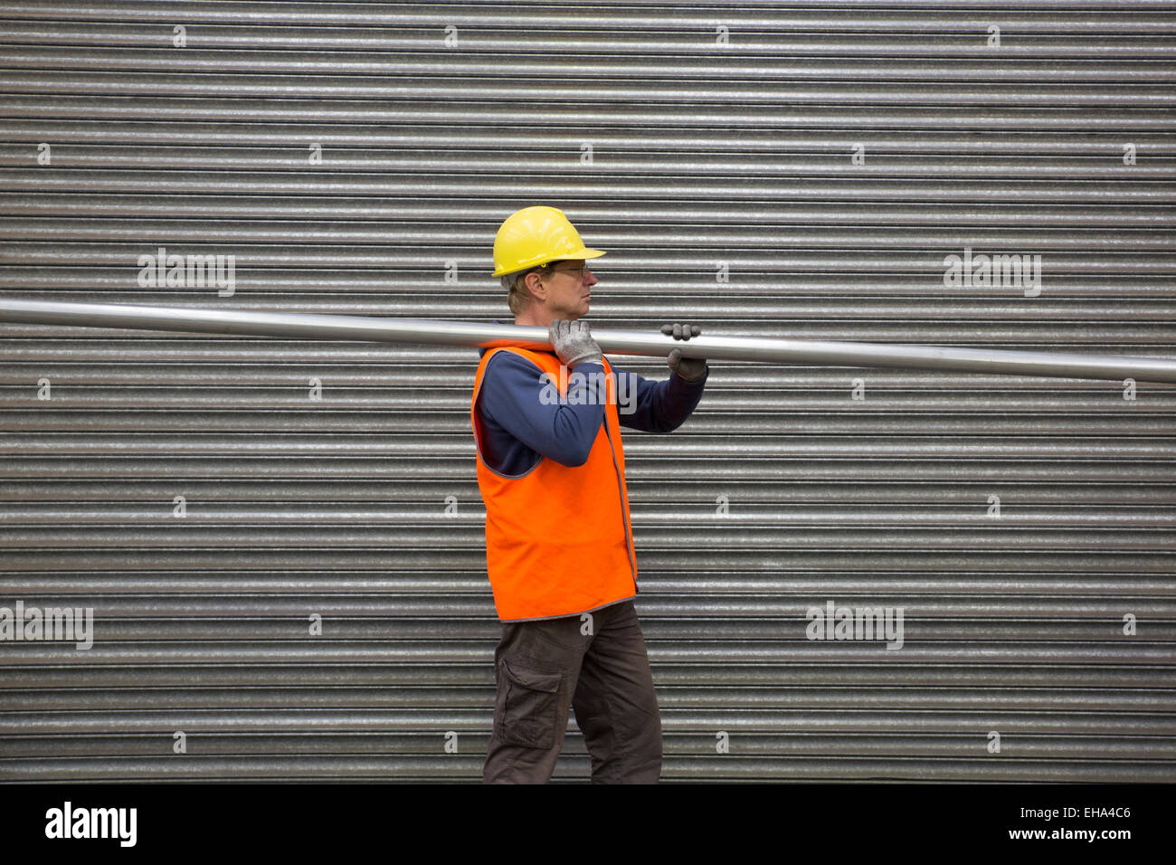 construction worker with steel pipe Stock Photo - Alamy