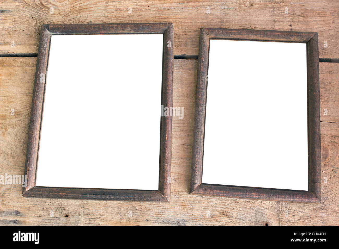 Two old photo frames on wooden background Stock Photo - Alamy