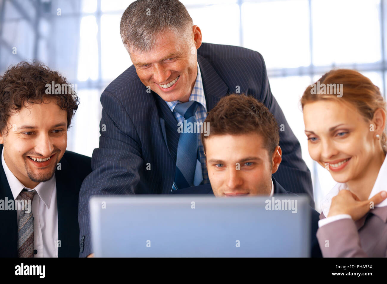 Closeup of a group of business people working on laptop with their ...