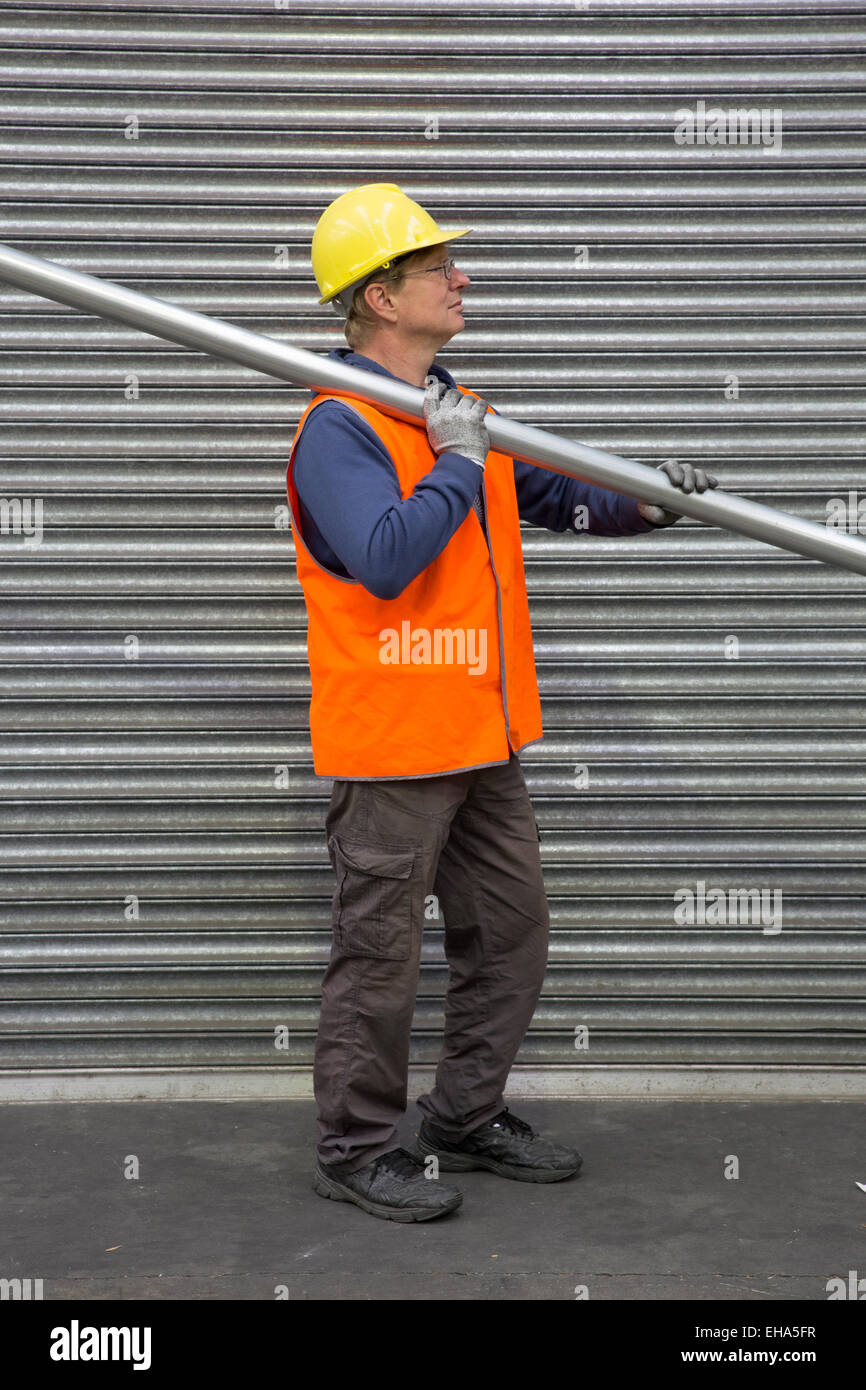 construction worker with a steel pipe Stock Photo - Alamy