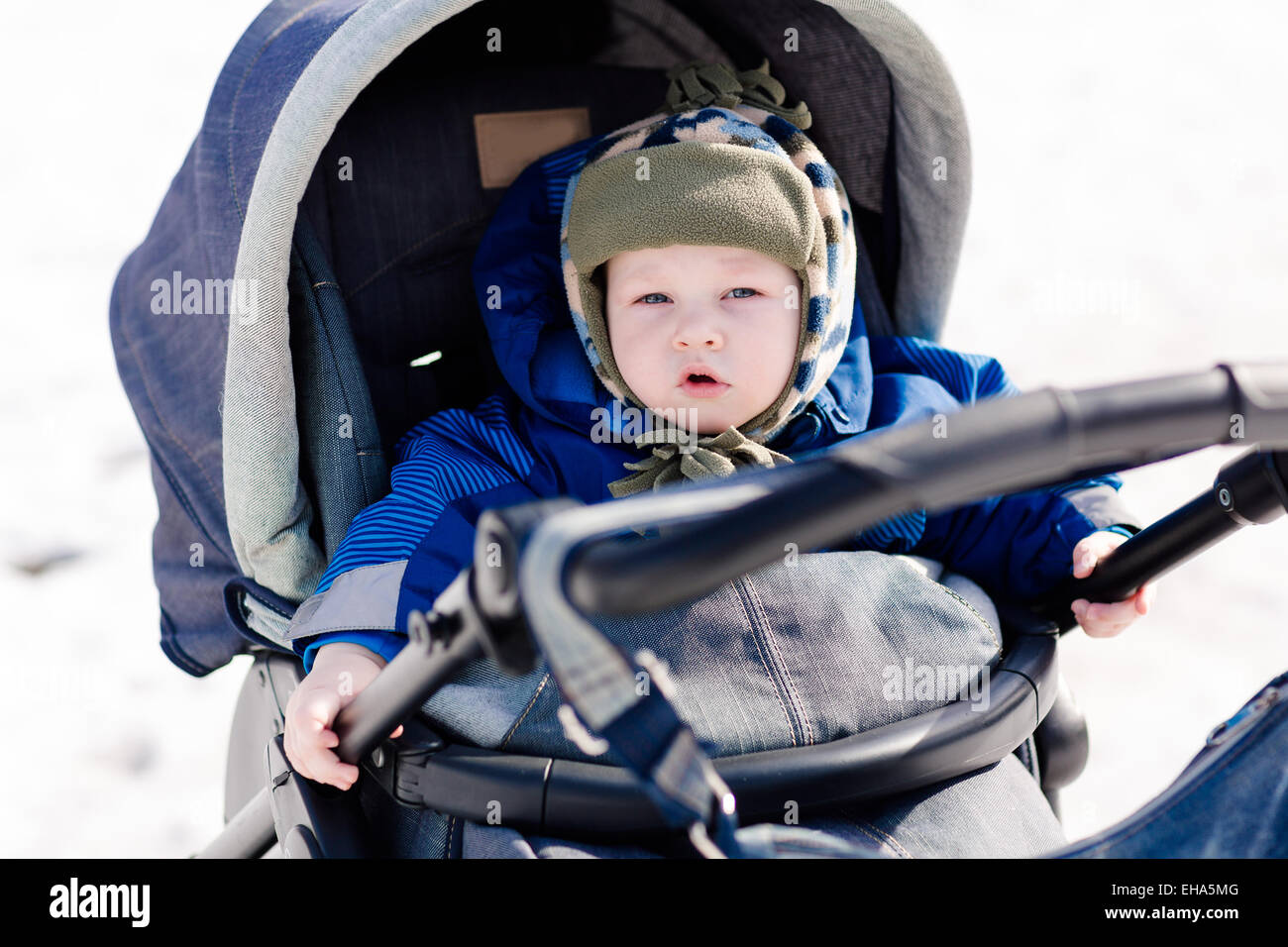 Cute little baby in a stroller outdoor in winter Stock Photo - Alamy