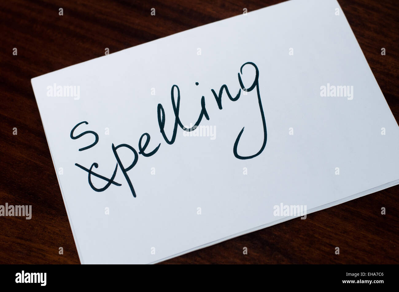 White paper sheet with word "spelling" lying on wooden table Stock ...