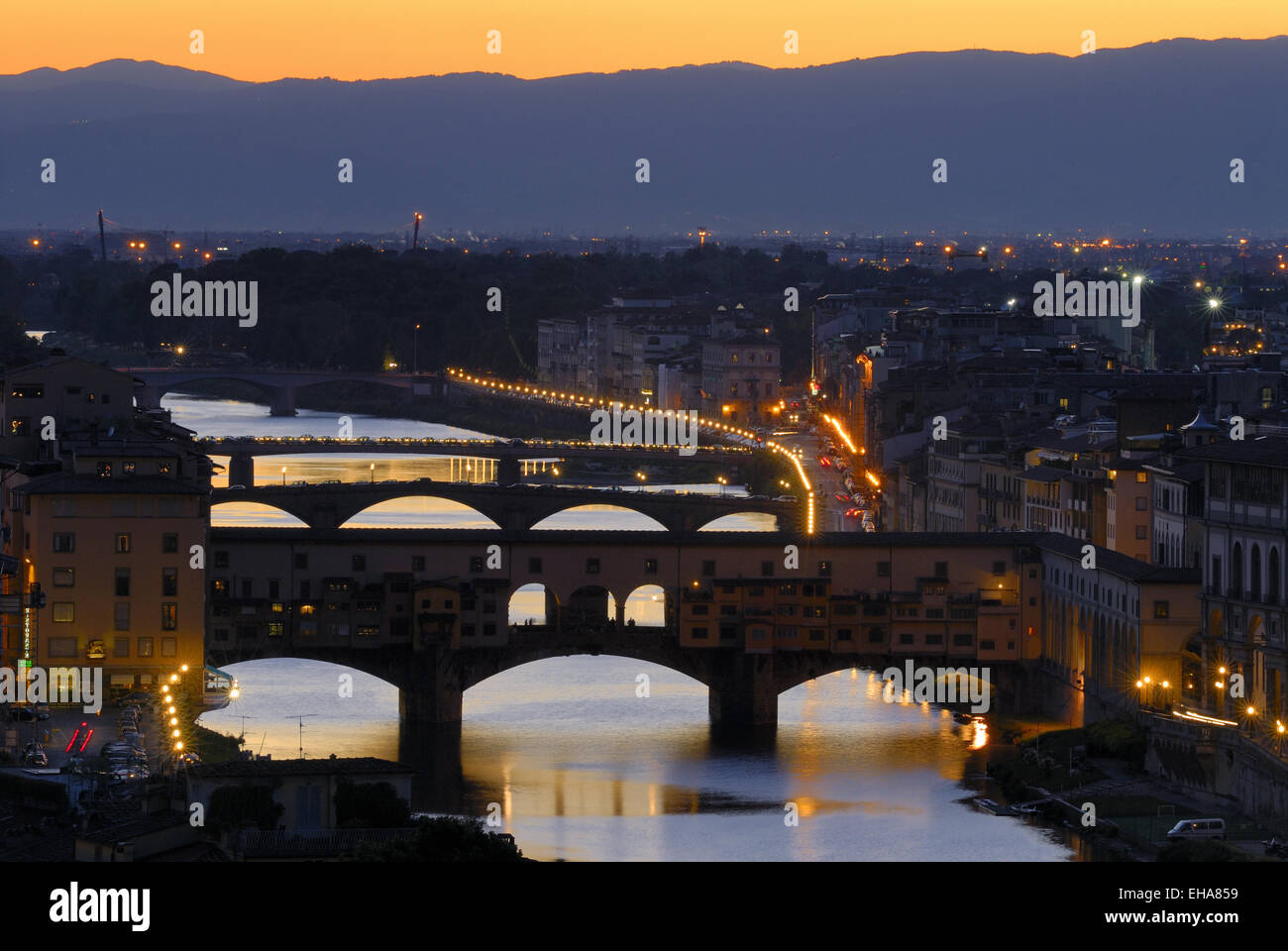 Florence skyline with Arno river and Ponte Vecchio bridge at twilight ...