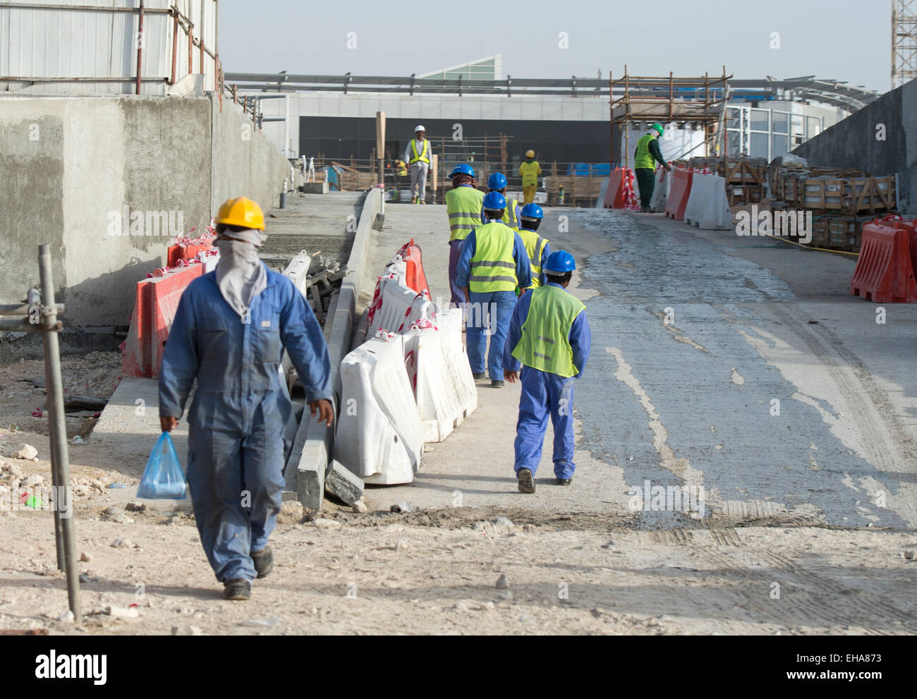 Doha, Qatar. 10th Mar, 2015. Builders work on a construction site in ...