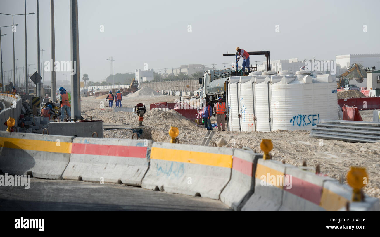 Doha, Qatar. 10th Mar, 2015. Builders work on a construction site in ...
