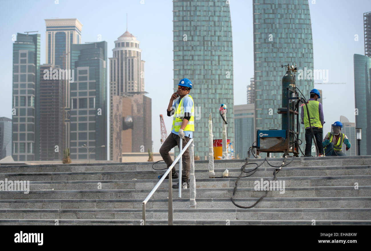 Doha, Qatar. 10th Mar, 2015. Builders work on a construction site in ...
