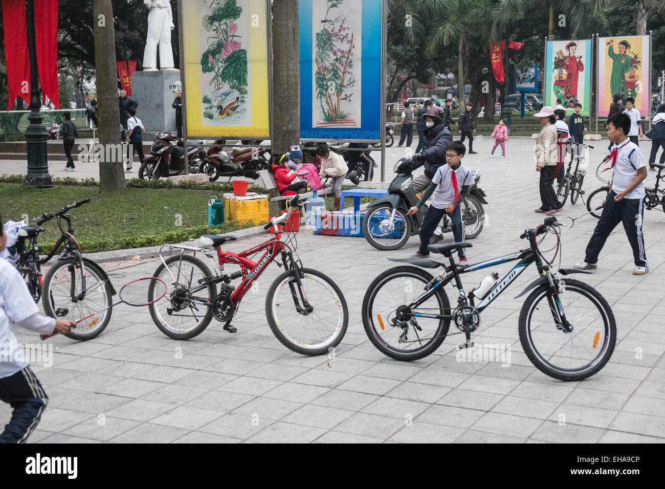 School children playing badminton,using their bicycles as a makeshift ...
