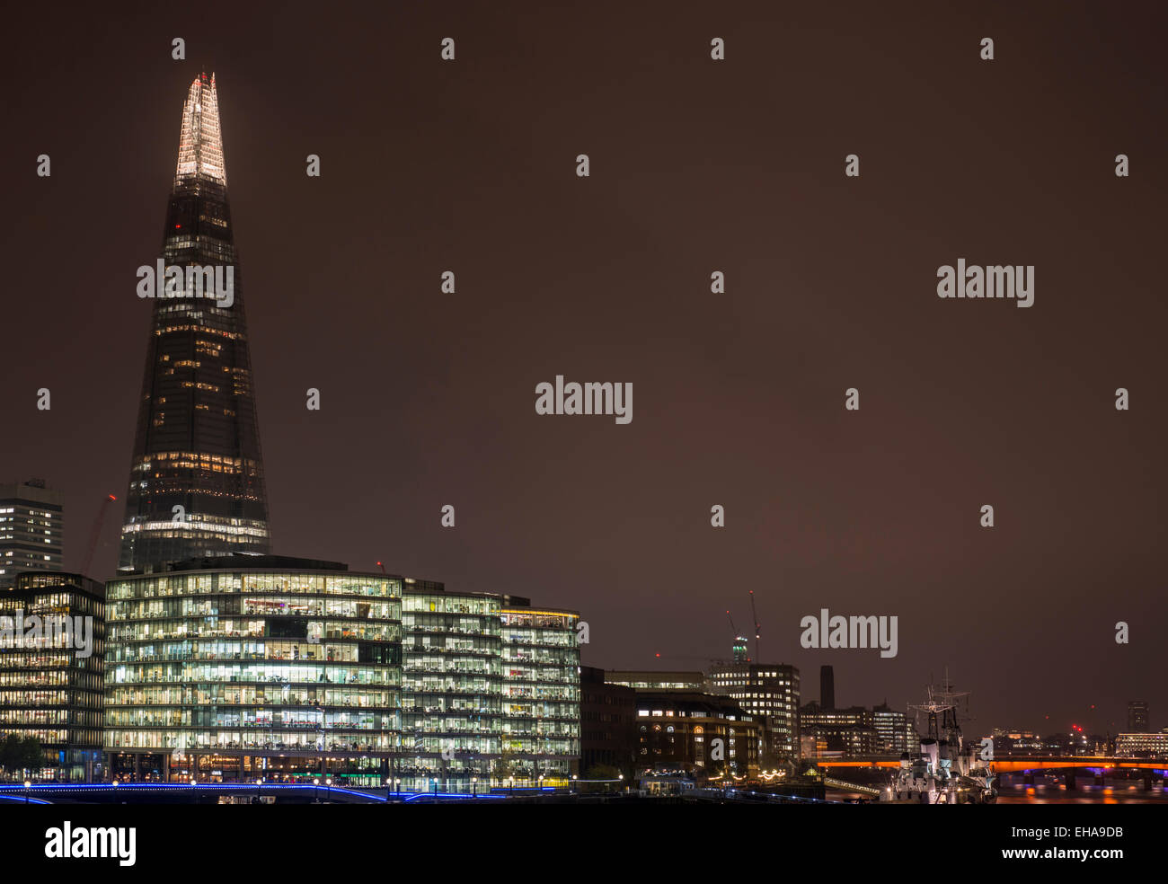 Night shot of the Shard building and city skyline in London, England ...