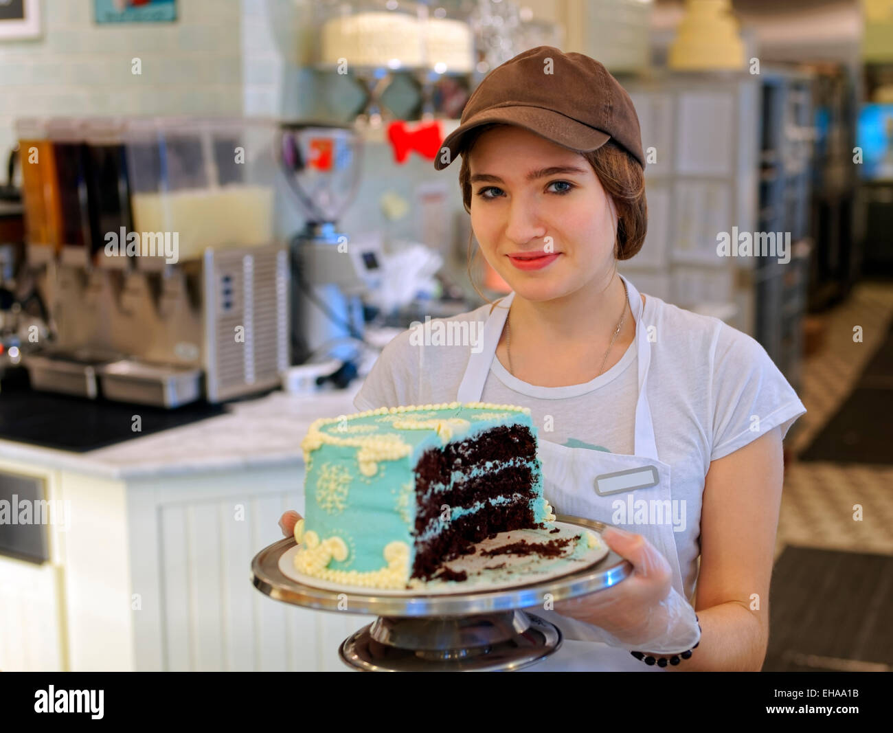 Young girl with creamy cake at the bakery Stock Photo - Alamy