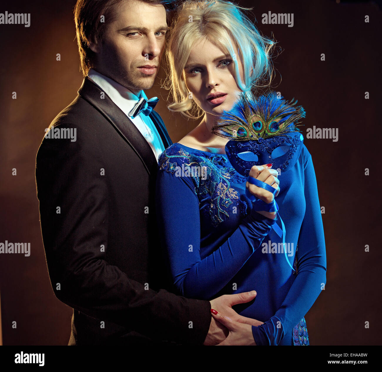 Couple holding a carnival blue mask Stock Photo - Alamy