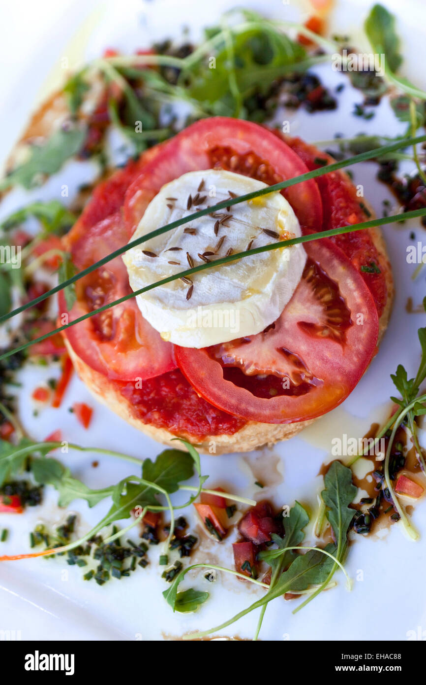 Toast with tomatoes and goat cheese, green salad and herbs Stock Photo ...