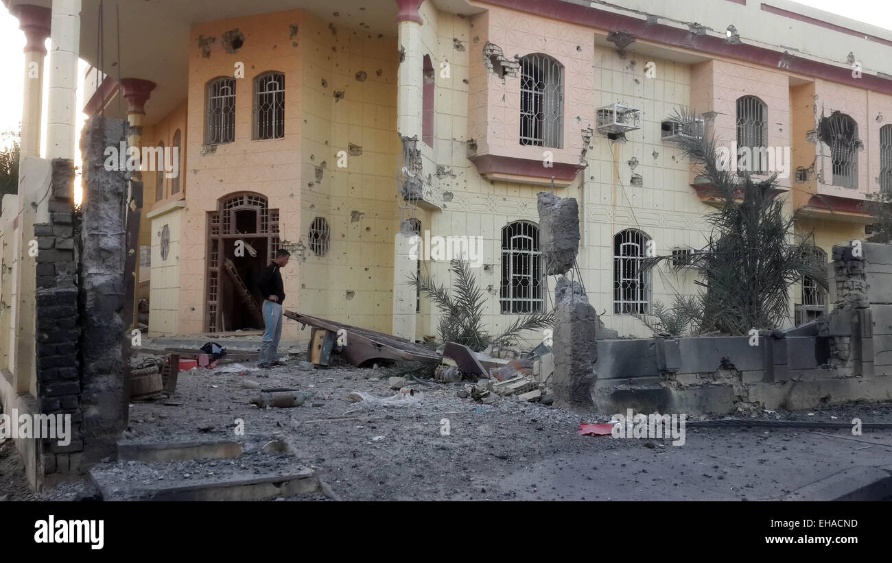 Fallujah, Iraq. 10th Mar, 2015. A man inspects destroyed buildings ...