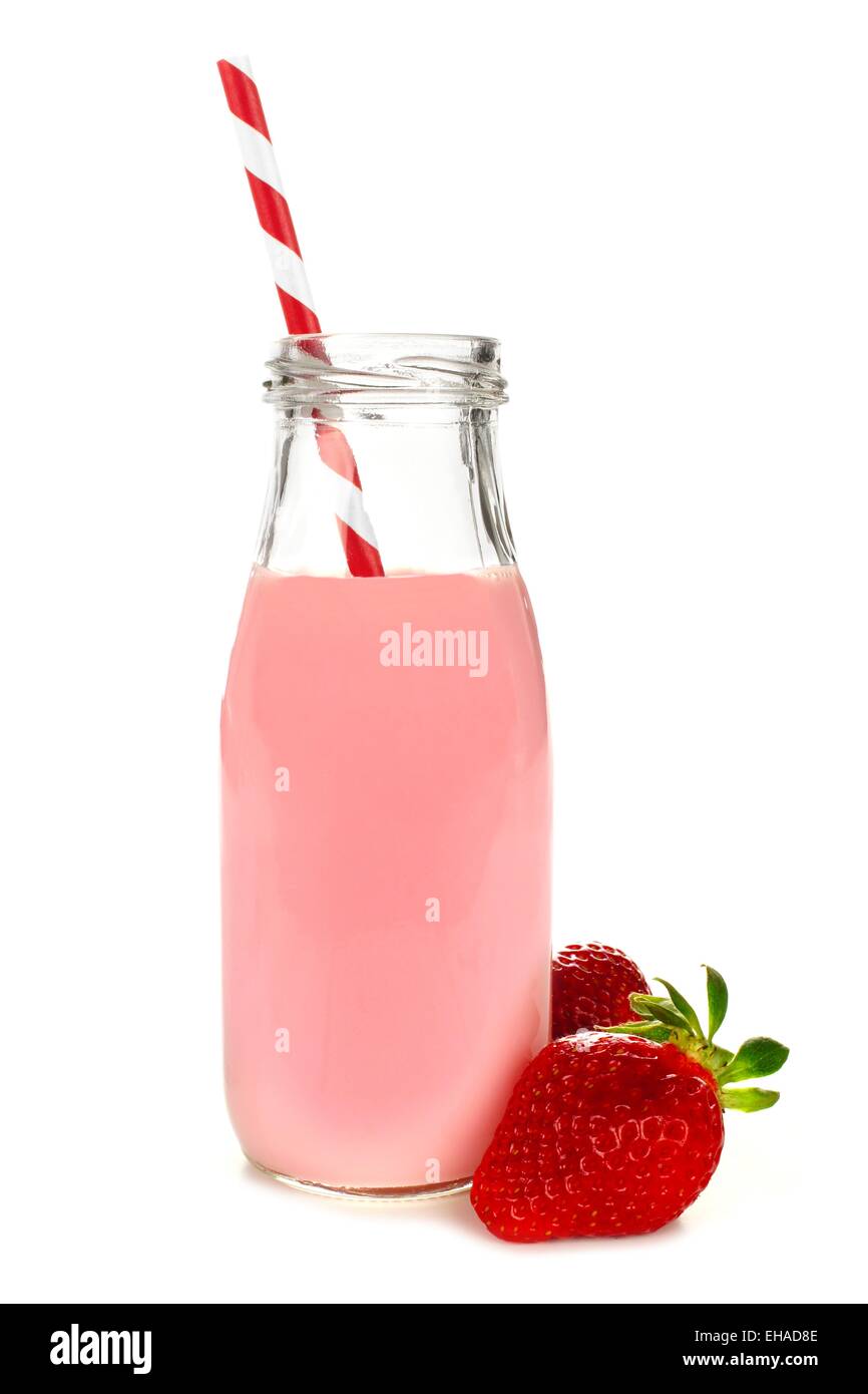 Strawberry milk with straw in a traditional bottle with berries ...