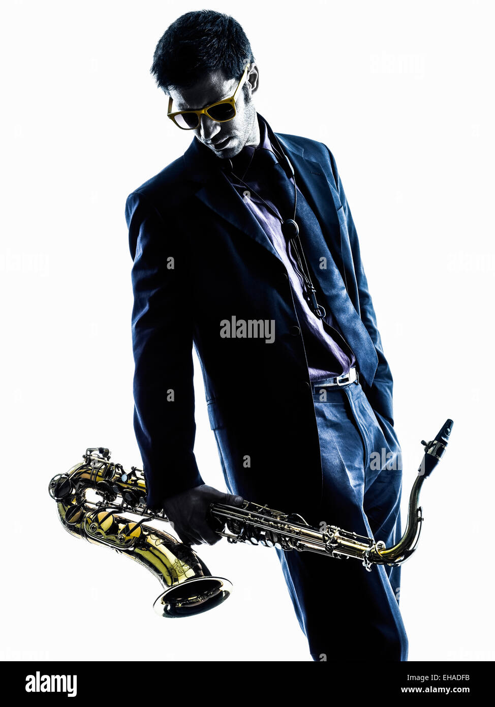 one caucasian man saxophonist playing saxophone player in studio ...