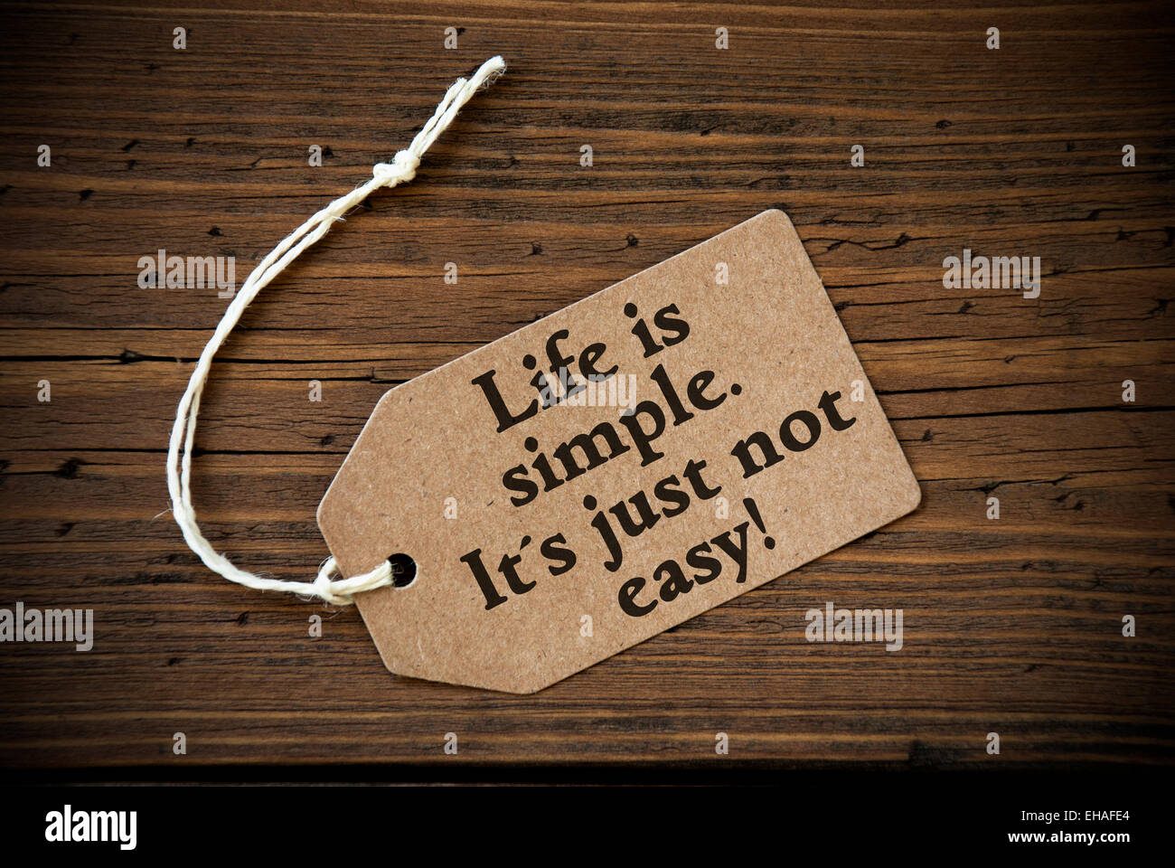 Close Up Of A Brown Label With White Ribbon On Wooden Background With ...