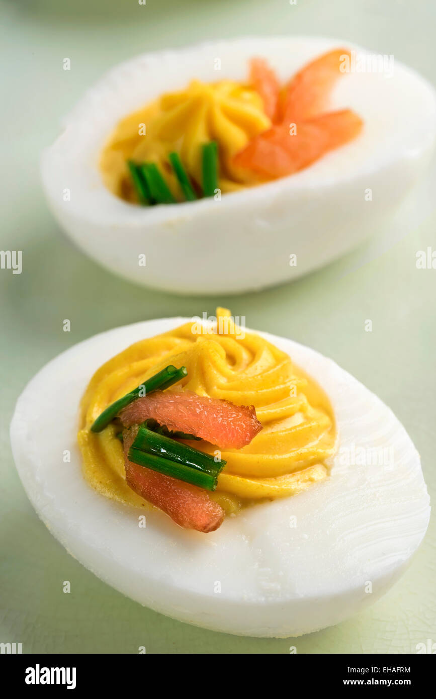 Freshly prepared deviled eggs with bits of smoked salmon and chives ...