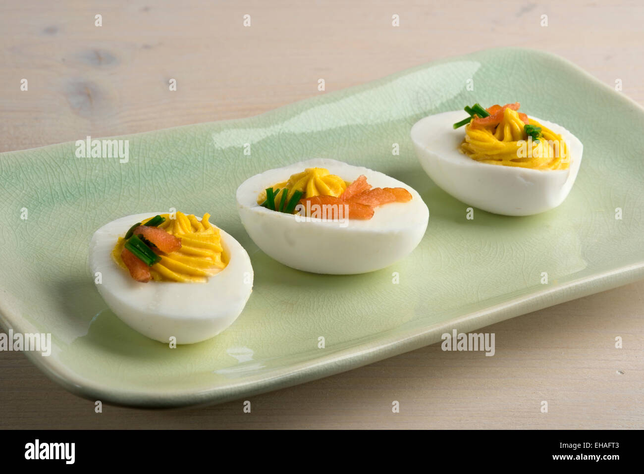 Freshly prepared deviled eggs with bits of smoked salmon and chives ...