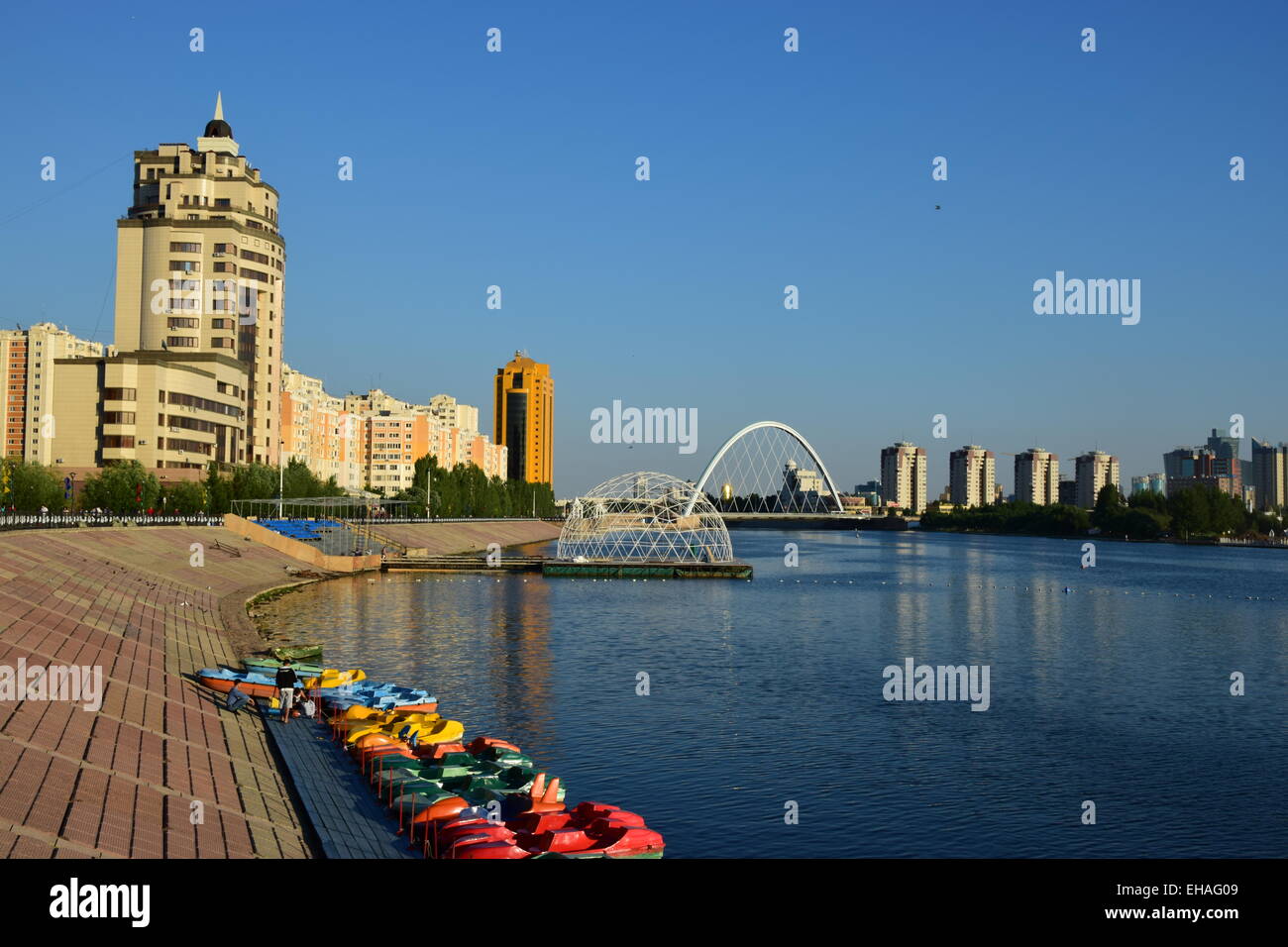 A city view in Astana, Kazakhstan, with a tower, bridge and the Ishim ...