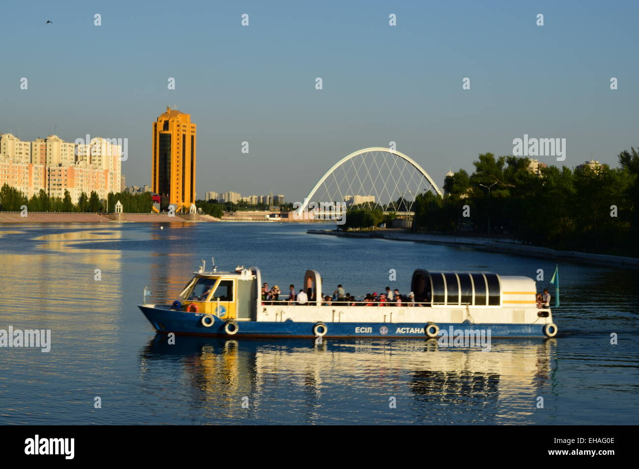 A city view in Astana, Kazakhstan, with a tower, bridge and the Ishim ...