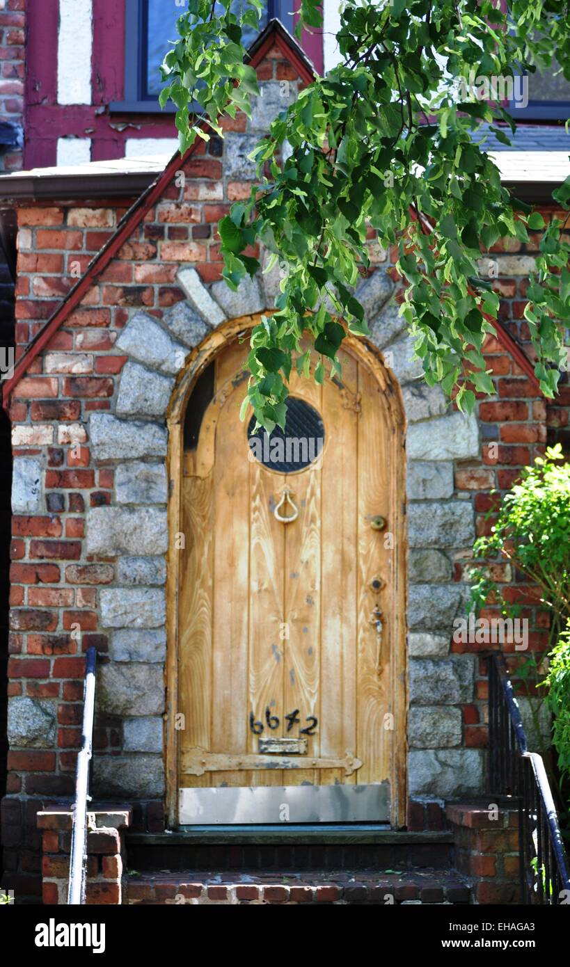 stone entrance with wooden door round window 6642 Stock Photo - Alamy