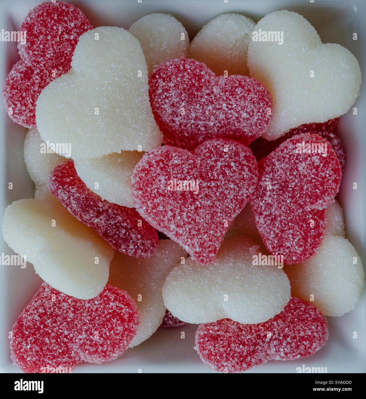 Chewy red and white gummy hearts fill a white bowl Stock Photo - Alamy