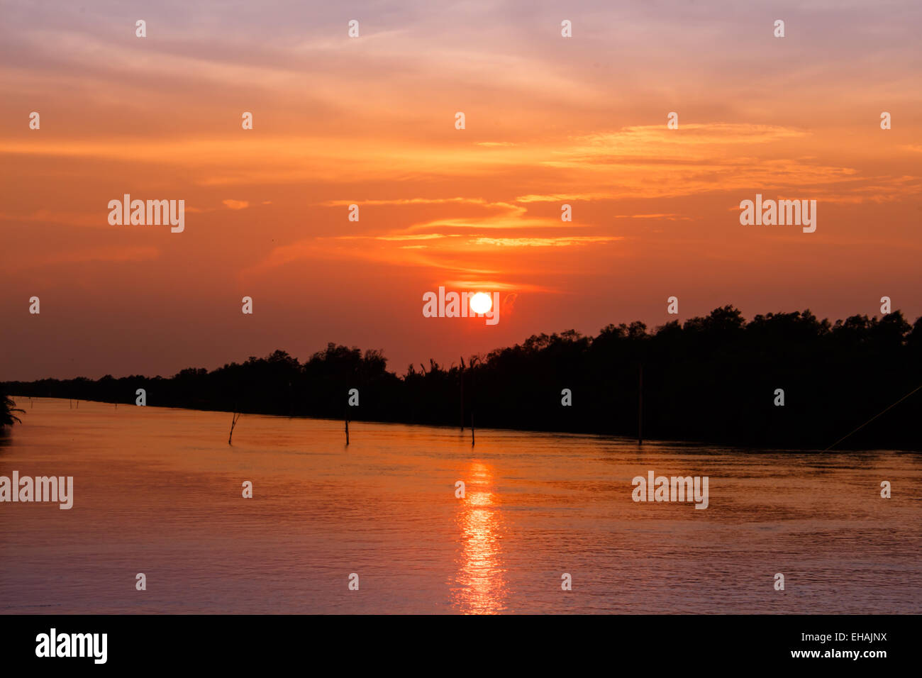 The sun rising river is reflective orange Stock Photo - Alamy