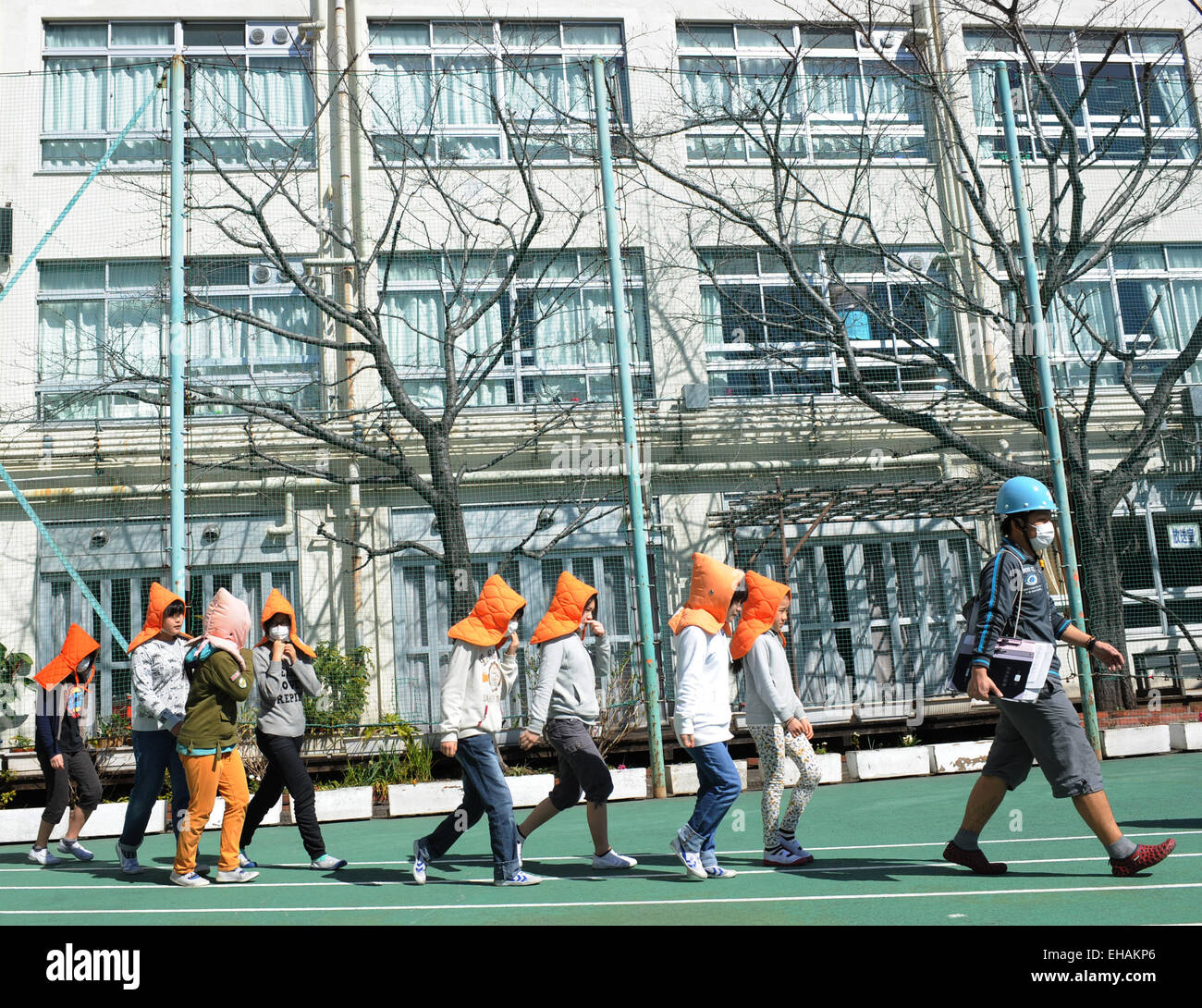 Tokyo, Japan. 11th Mar, 2015. A teacher and elementary school children ...