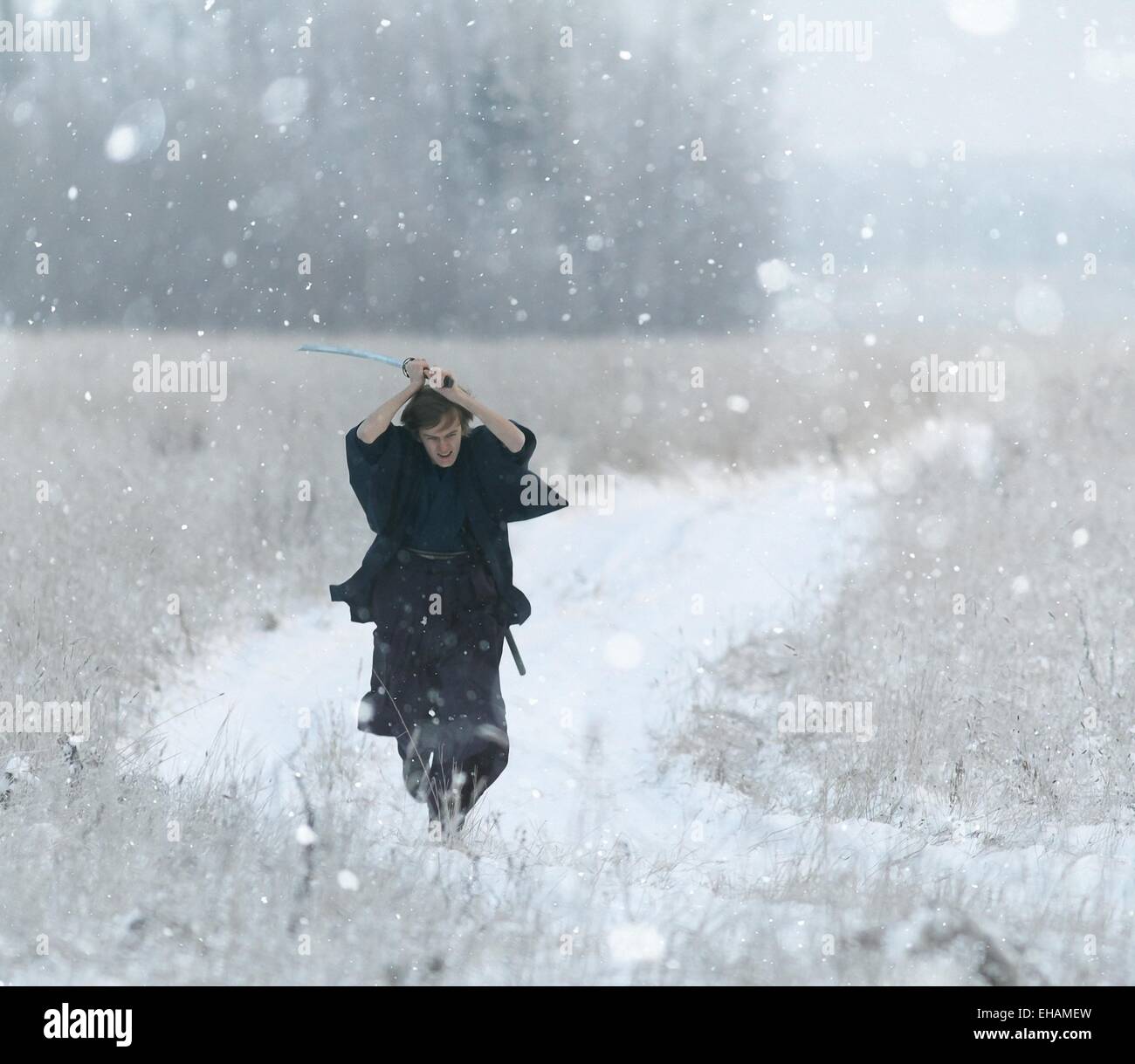 running samurai wearing a kimono in a winter field dressed in black ...