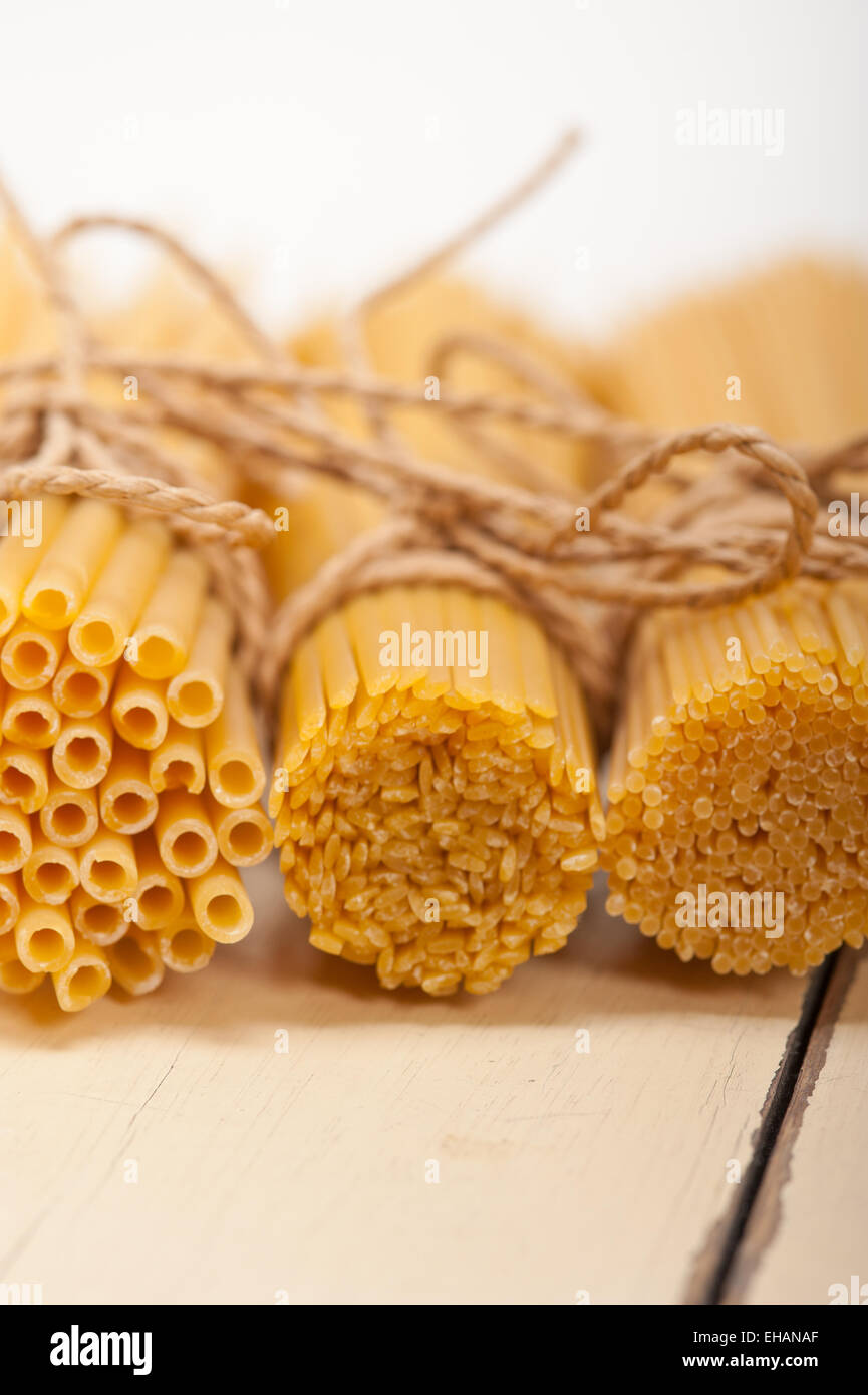 bunch of Italian pasta type on a white rustic table Stock Photo - Alamy