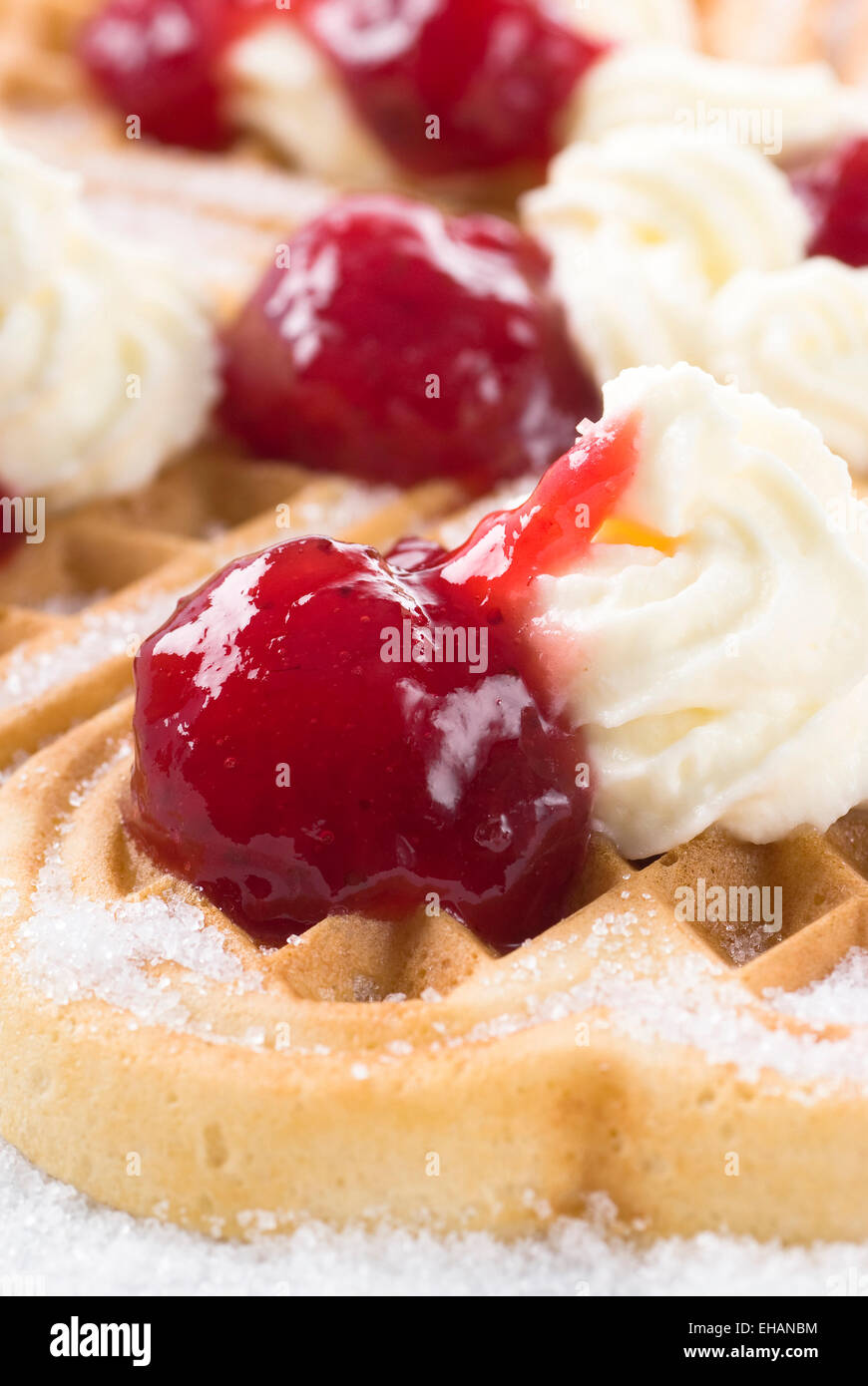 Waffles with cream, sugar and strawberry jam Stock Photo - Alamy