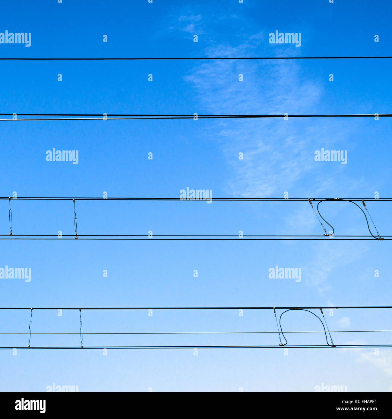 Railway cables into the blue sky Stock Photo - Alamy