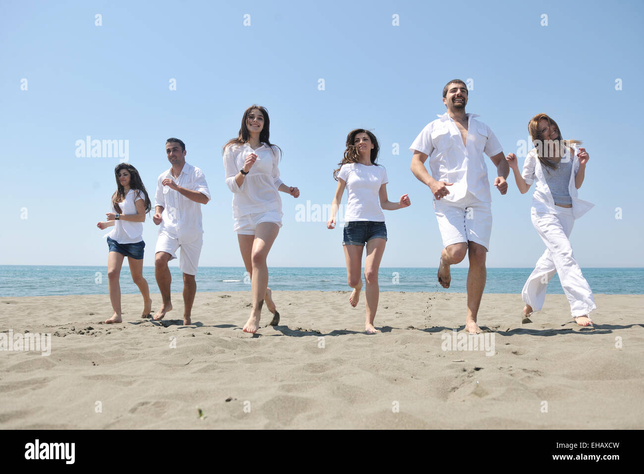 happy people group have fun and running on beach Stock Photo - Alamy