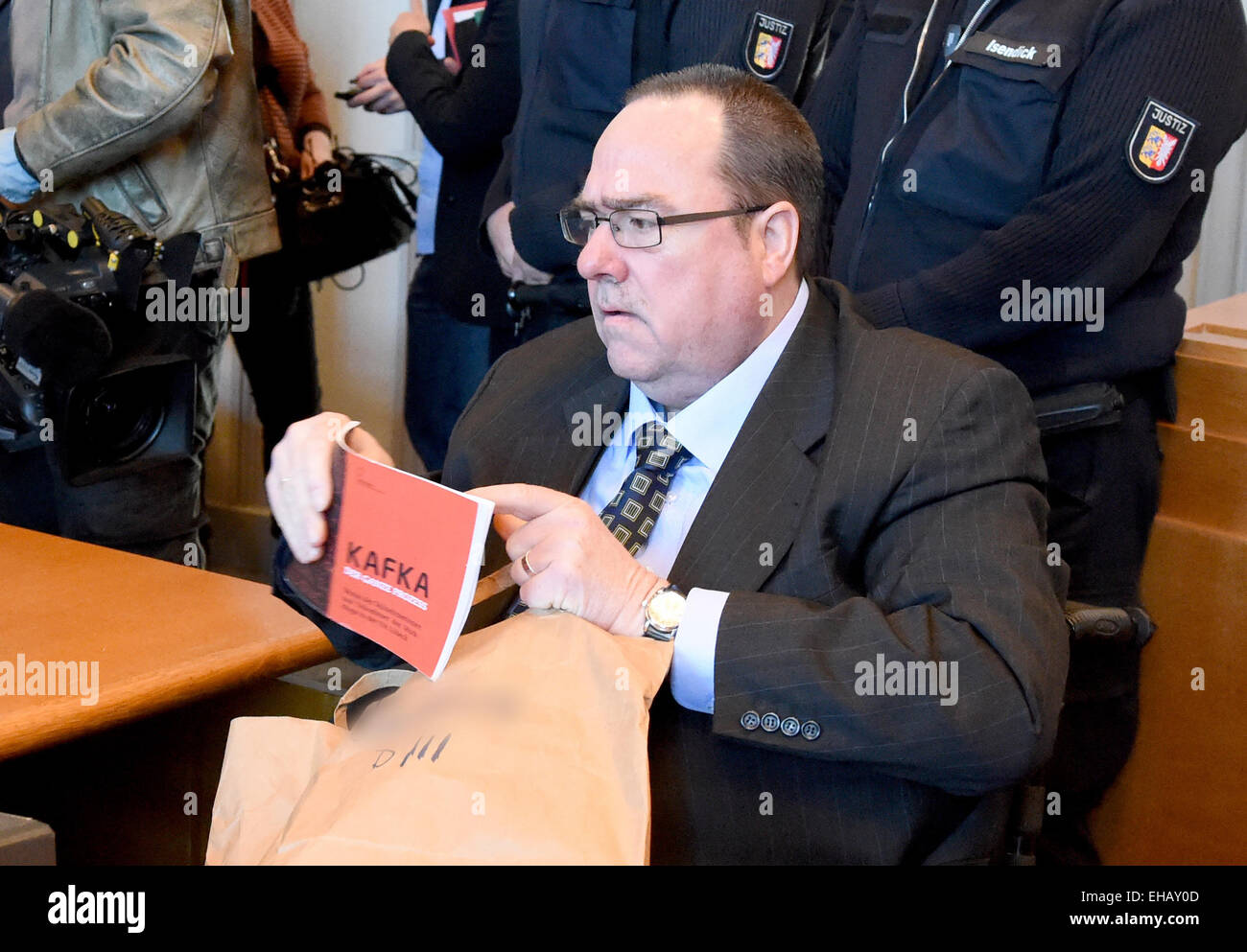 Kiel, Germany. 11th Mar, 2015. The 55-year-old defendant unpacks a ...