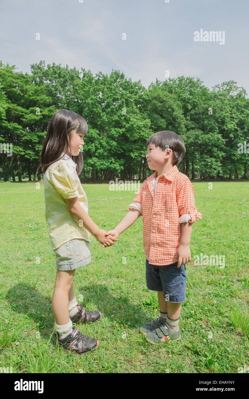 Japanese kid shaking hands in a park Stock Photo - Alamy