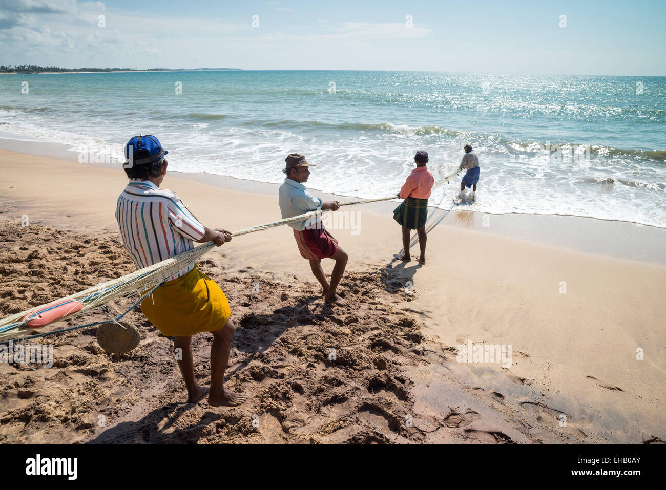 Fishermen pull in their nets on a beach, Tangalle, Sri Lanka, Asia ...