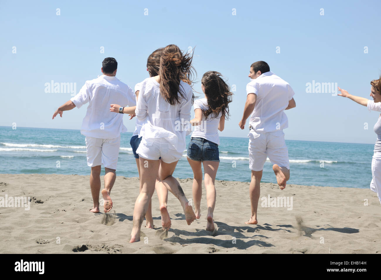 happy people group have fun and running on beach Stock Photo - Alamy