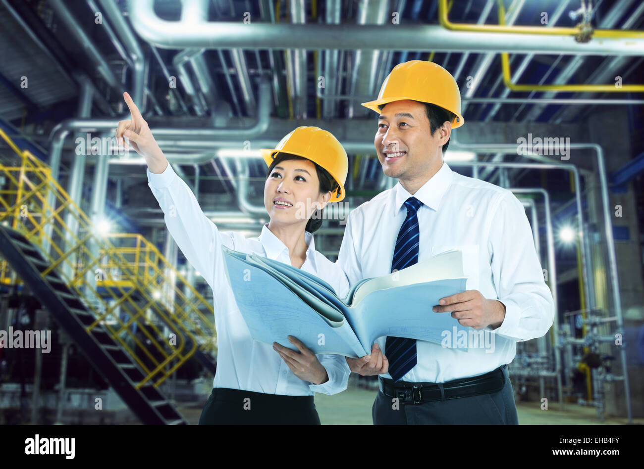 Two staff with drawings to plant guide work Stock Photo - Alamy
