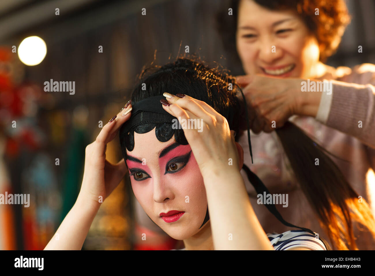 The stylist for the Peking Opera actors doing hair style Stock Photo ...