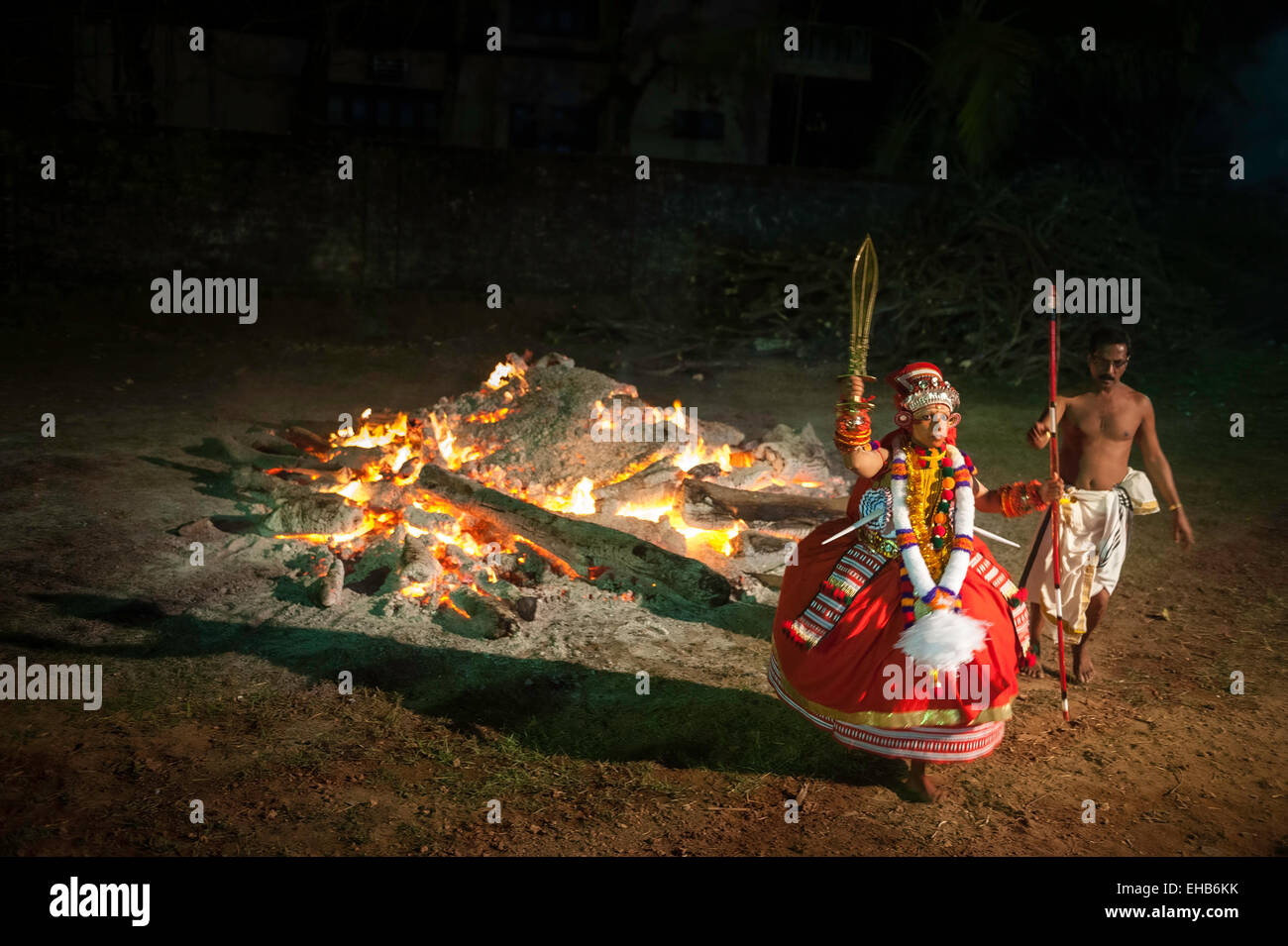 Theyyam Dancer, it taking blessing from fire Stock Photo - Alamy