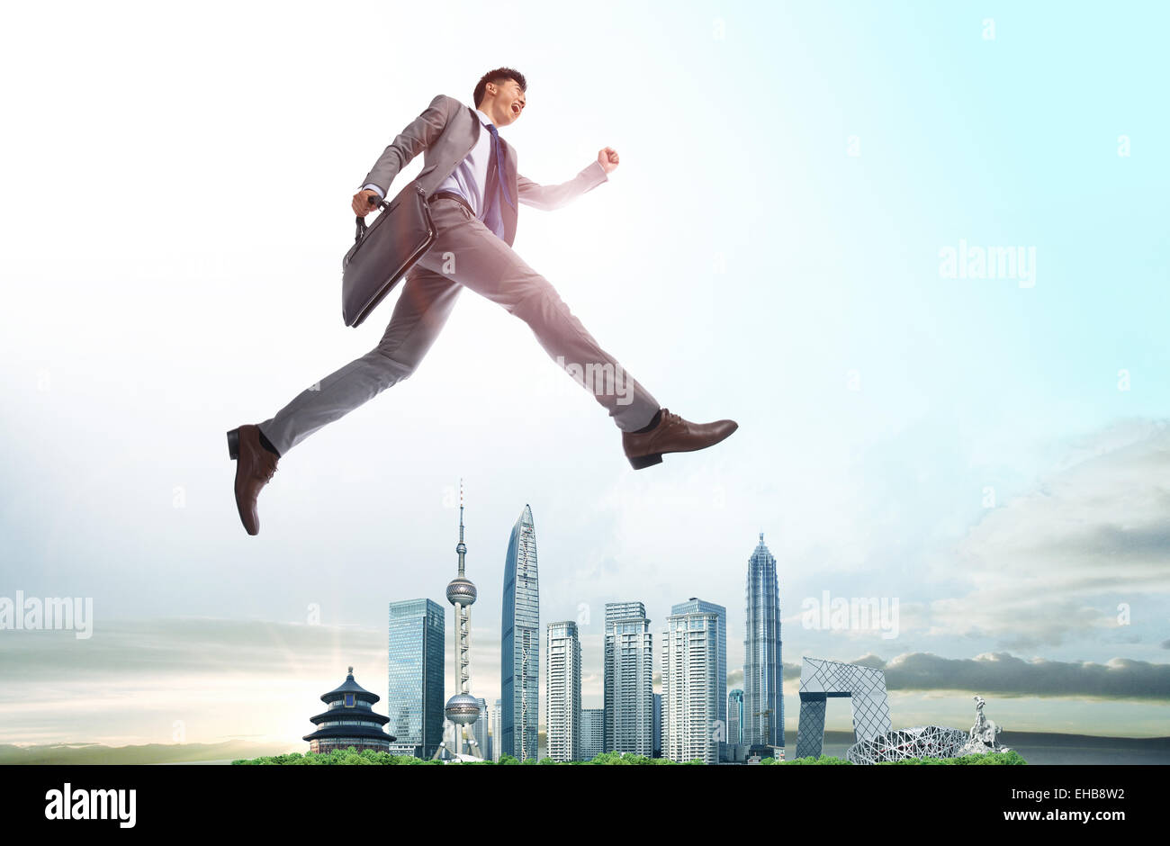 The business man jumps over the city Stock Photo - Alamy