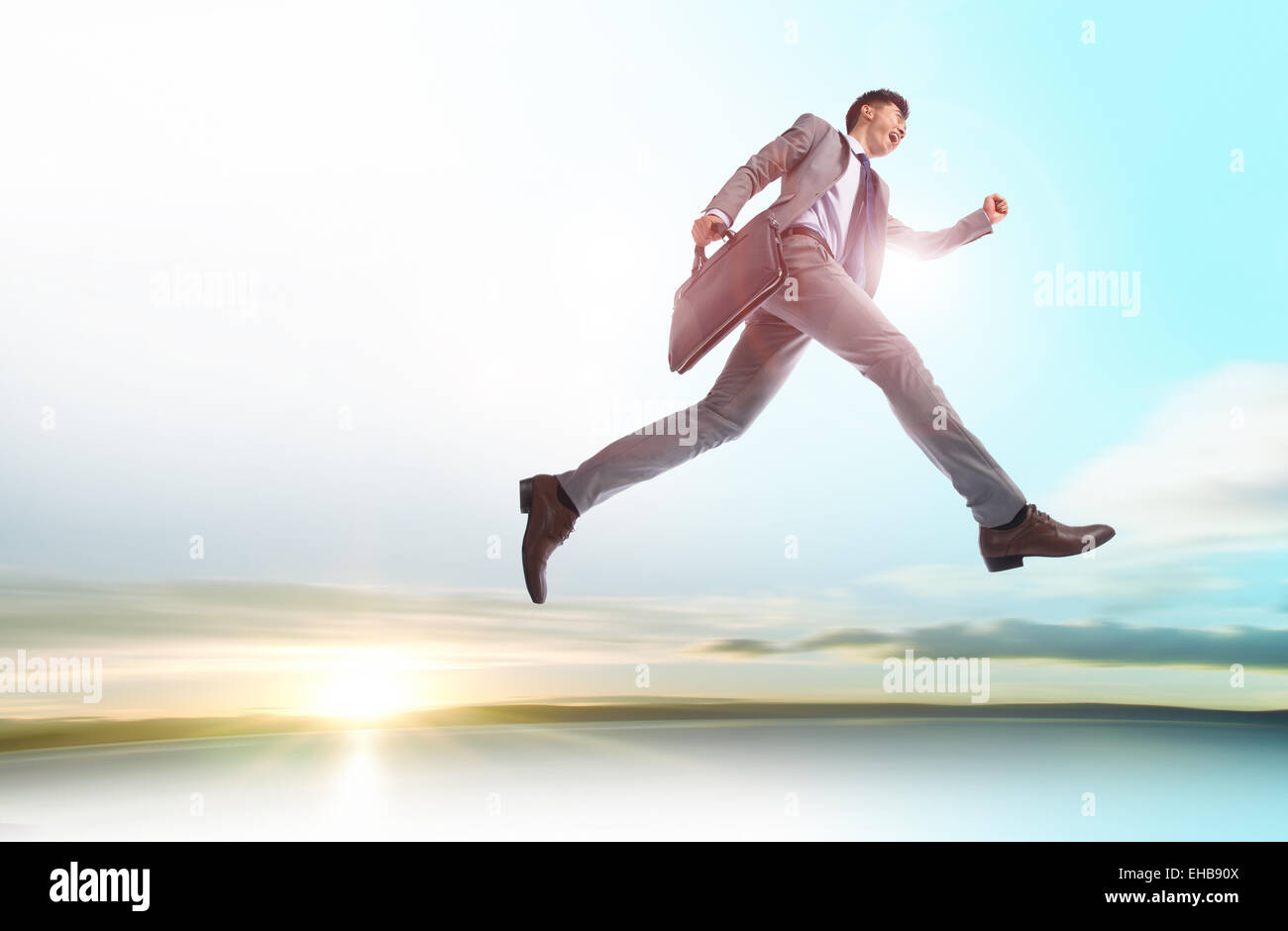 Business man jumping on the surface of the lake Stock Photo - Alamy
