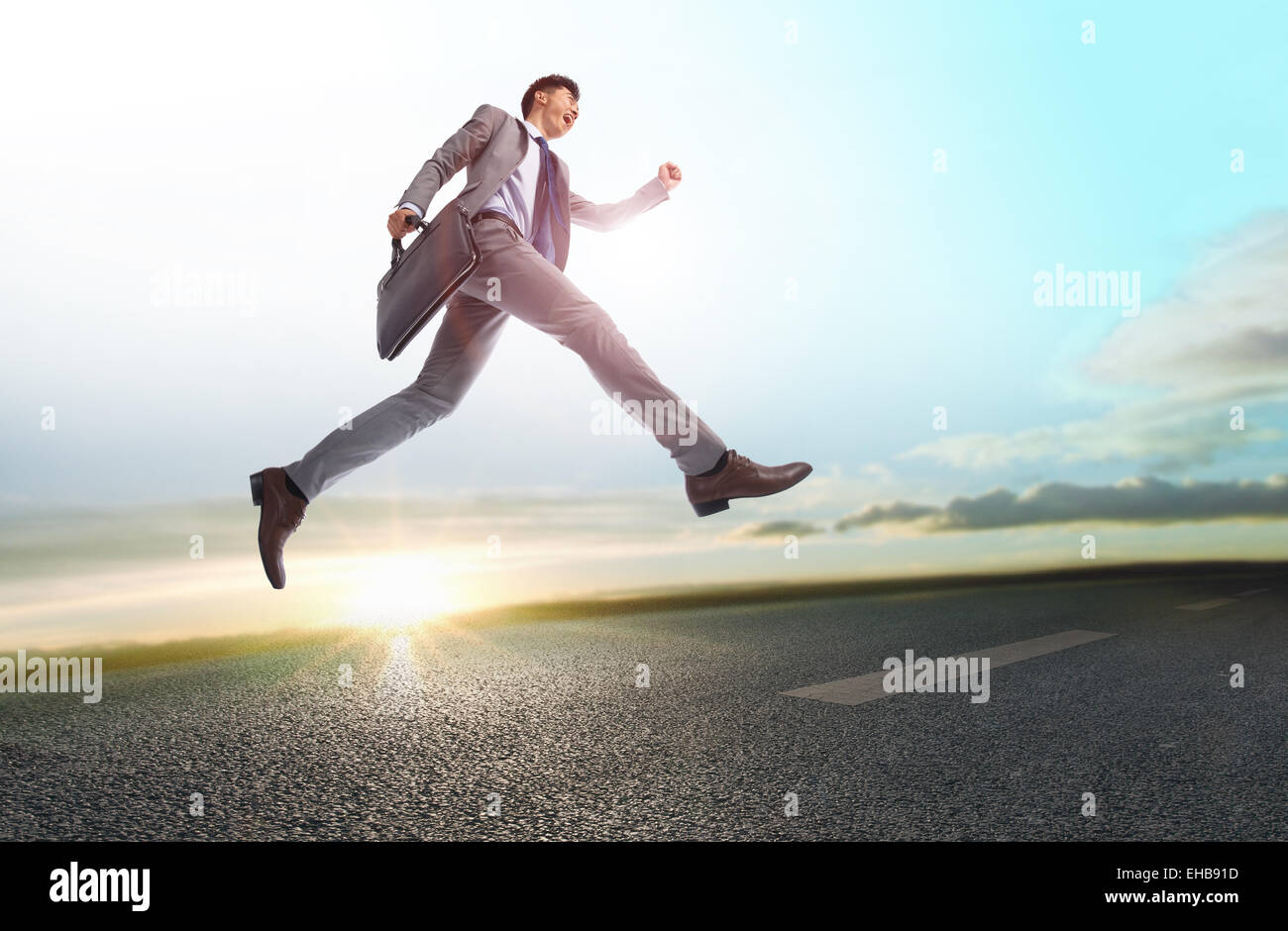 Business man jumps over the road Stock Photo - Alamy