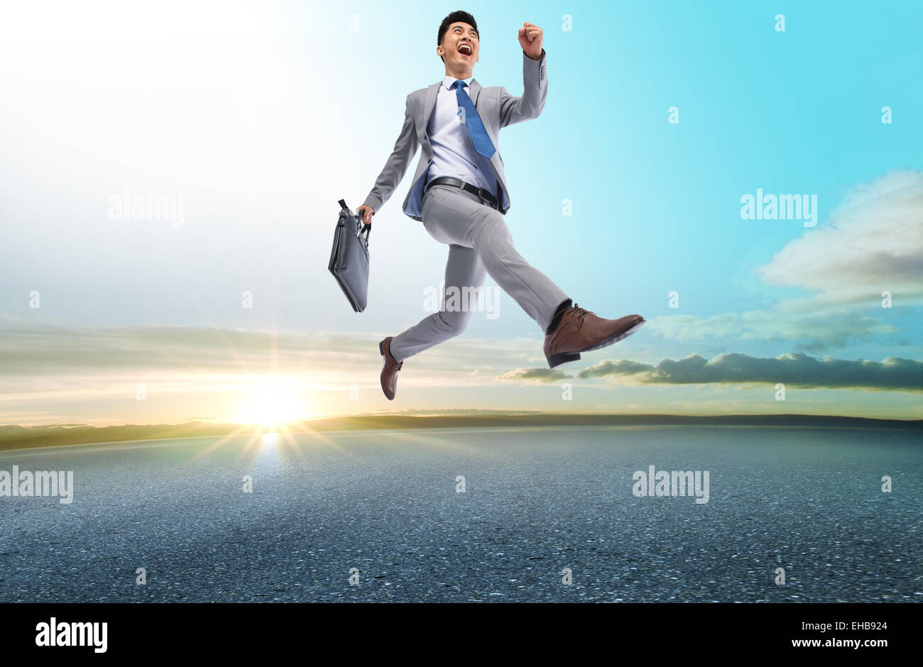 Business man jumps over the road Stock Photo - Alamy