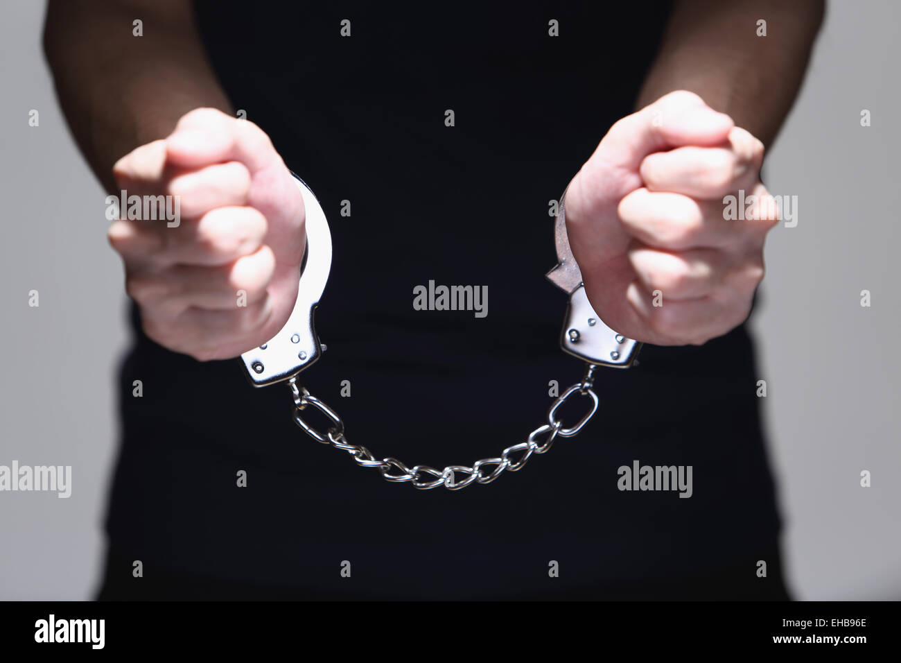 Handcuffed arms hi-res stock photography and images - Alamy