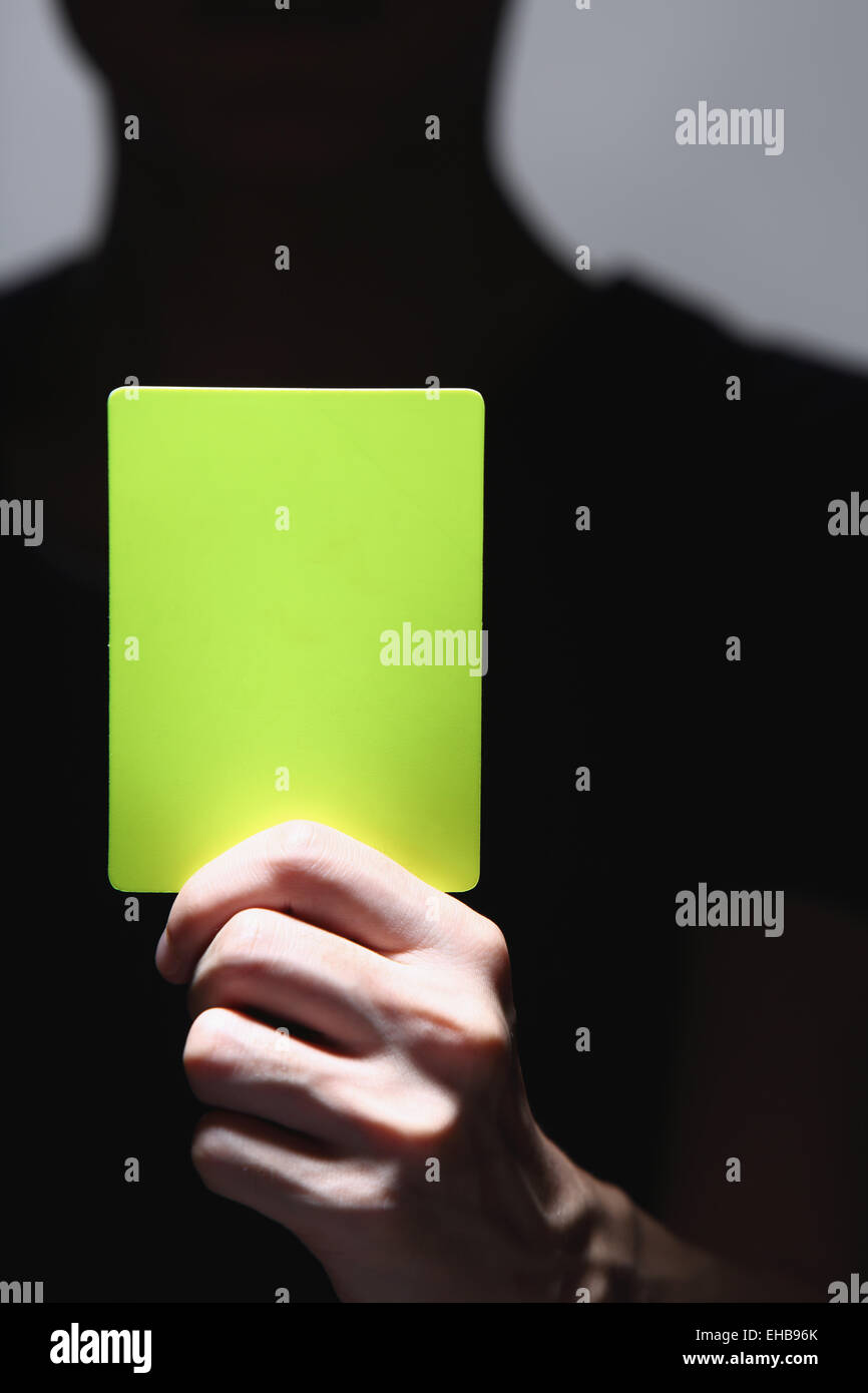 Man holding yellow card Stock Photo - Alamy